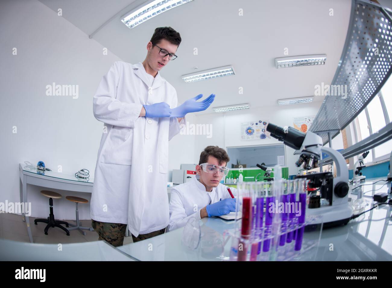 Group of young medical students doing research together in chemistry ...