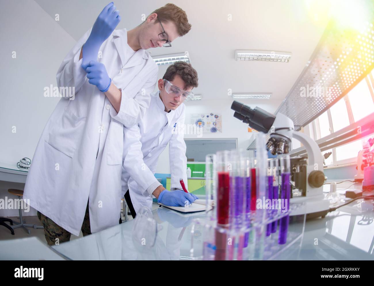 Group of young medical students doing research together in chemistry ...