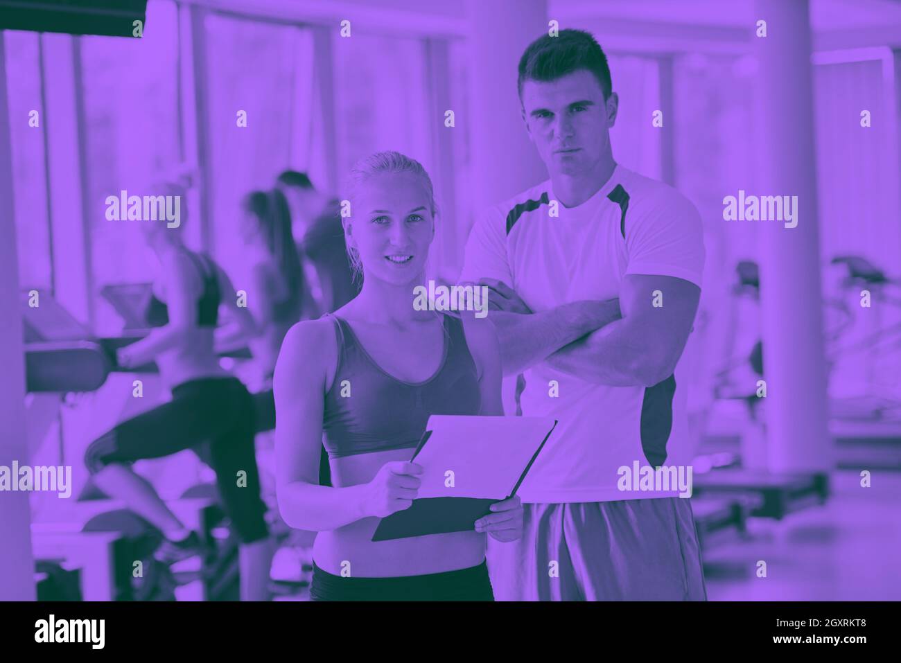 group portrait of healthy and fit young people in fitness gym duo tone ...