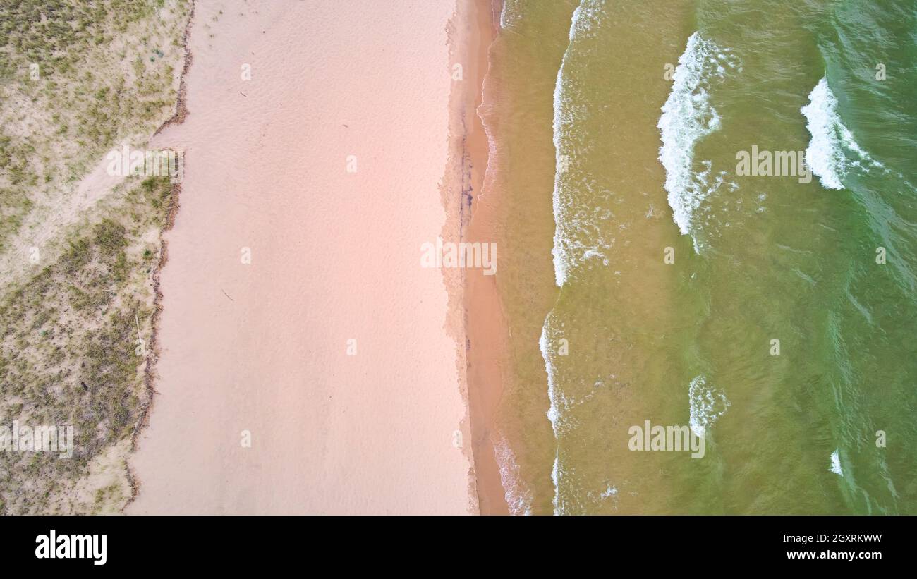 Aerial looking down at beach and sand dunes with waves of water Stock ...