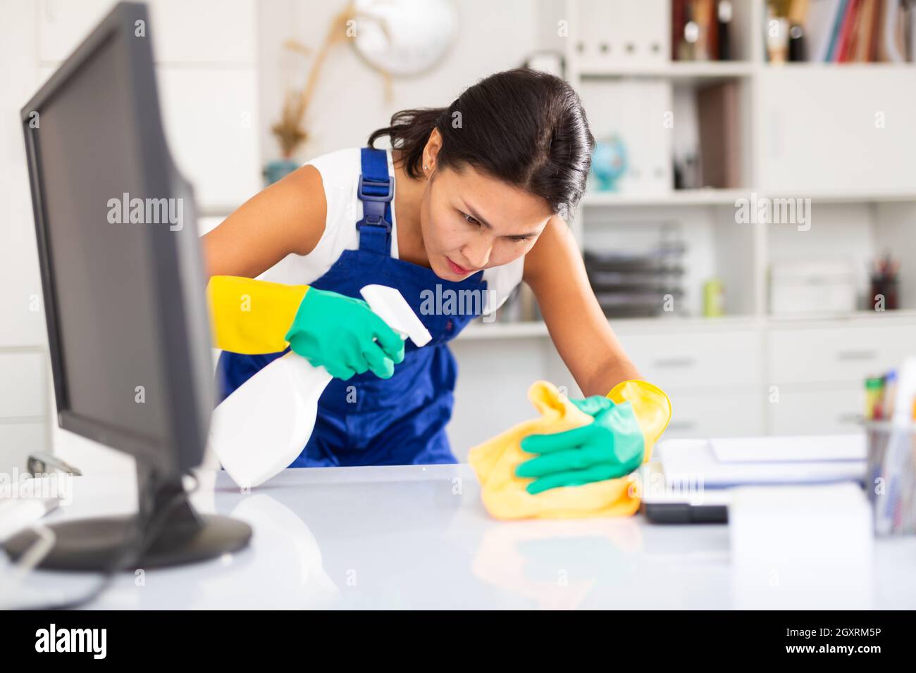 Female cleaner working productively on task Stock Photo - Alamy
