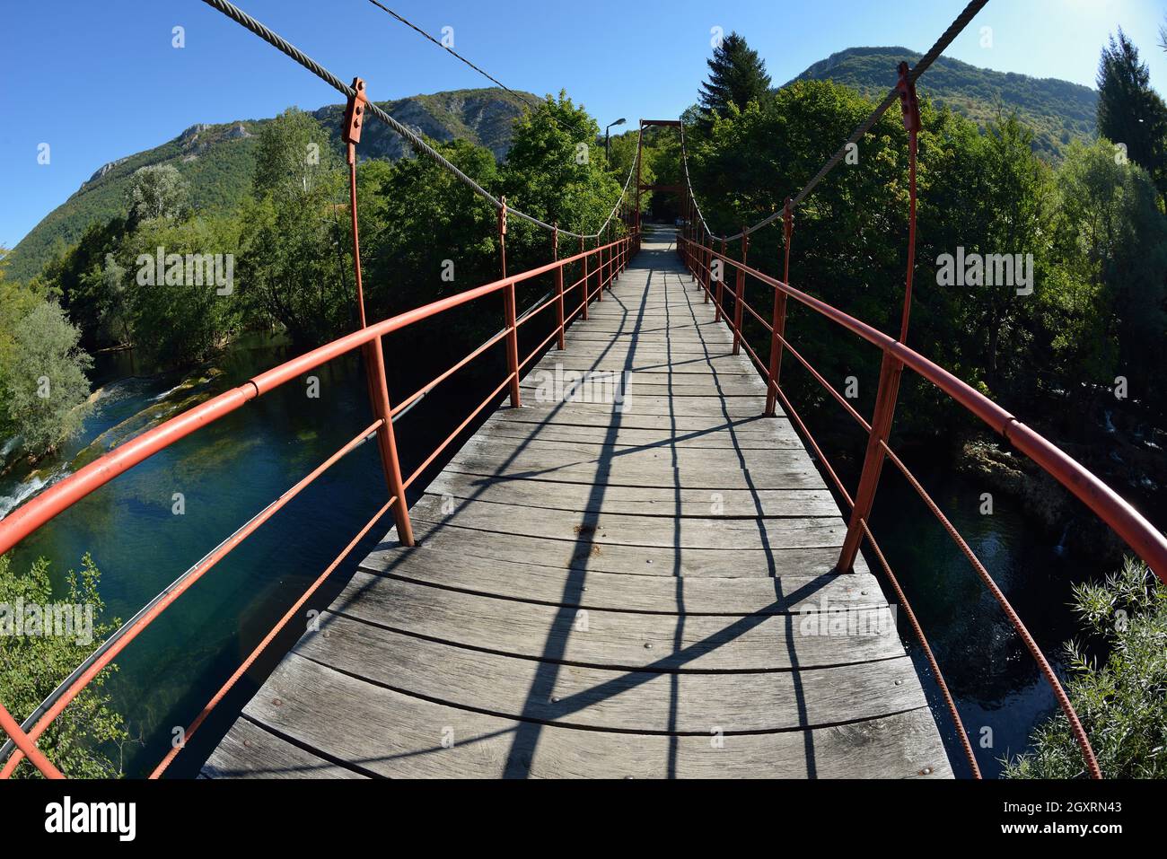 red wooden bridge over wild river in beautiful nature in summer Stock ...