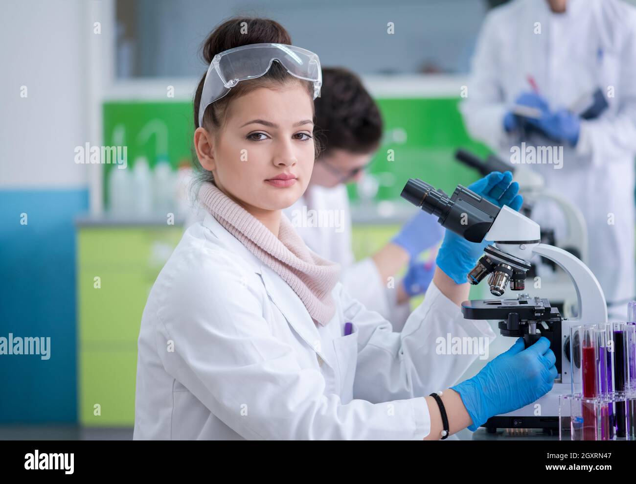 Group of young medical students doing research together in chemistry ...
