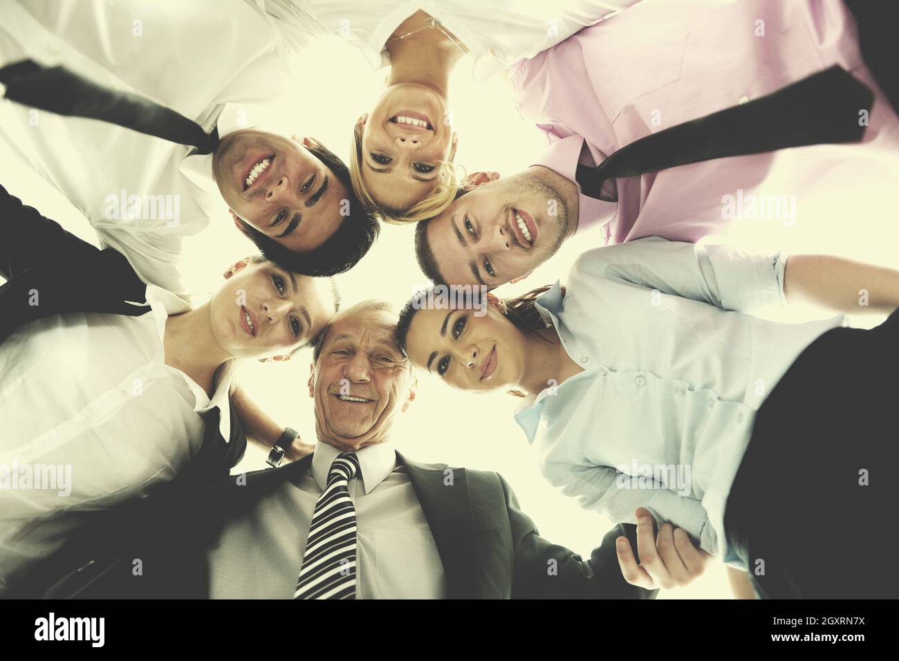 Closeup of happy business people with their heads together representing ...