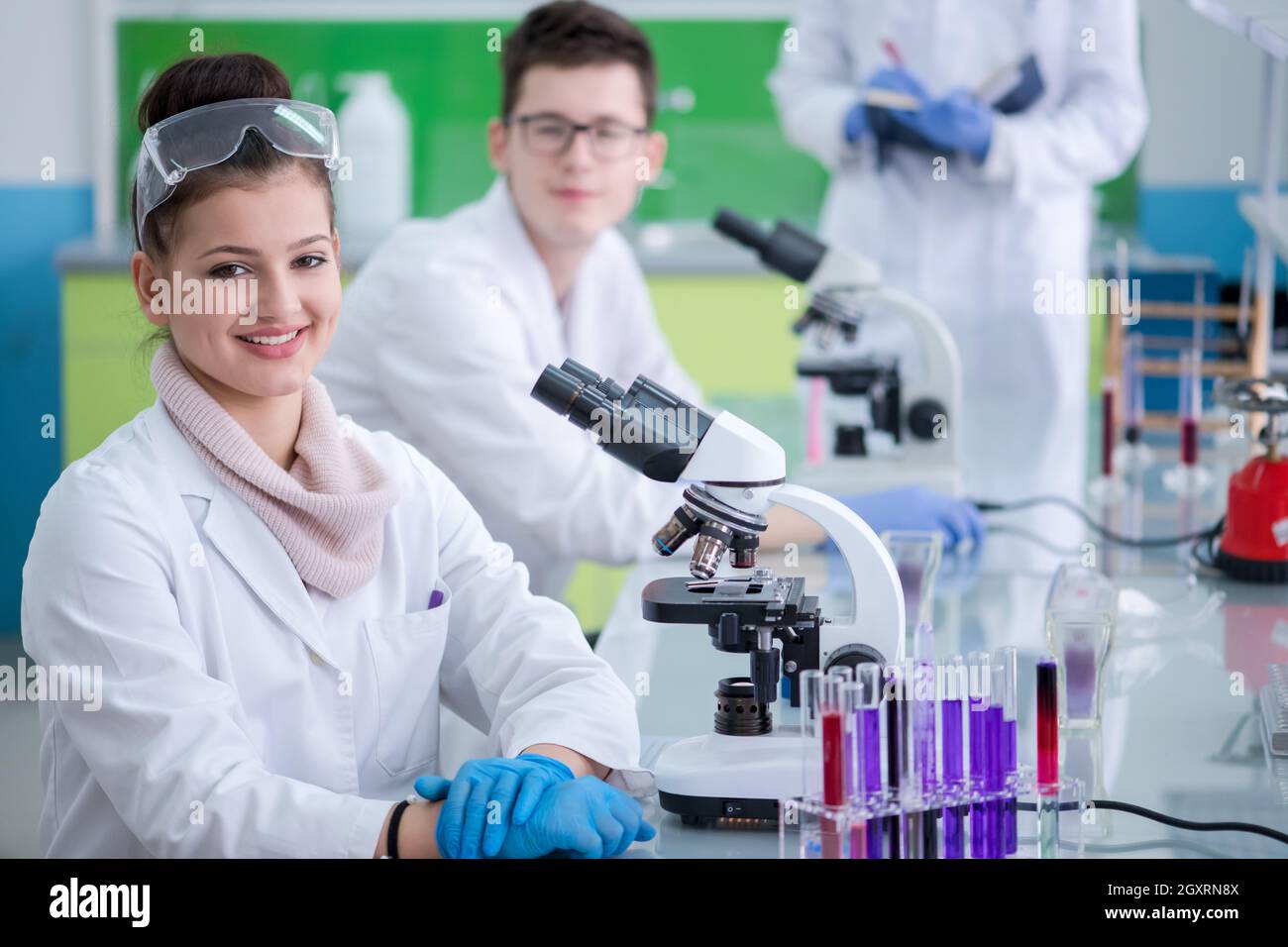 Group of young medical students doing research together in chemistry ...