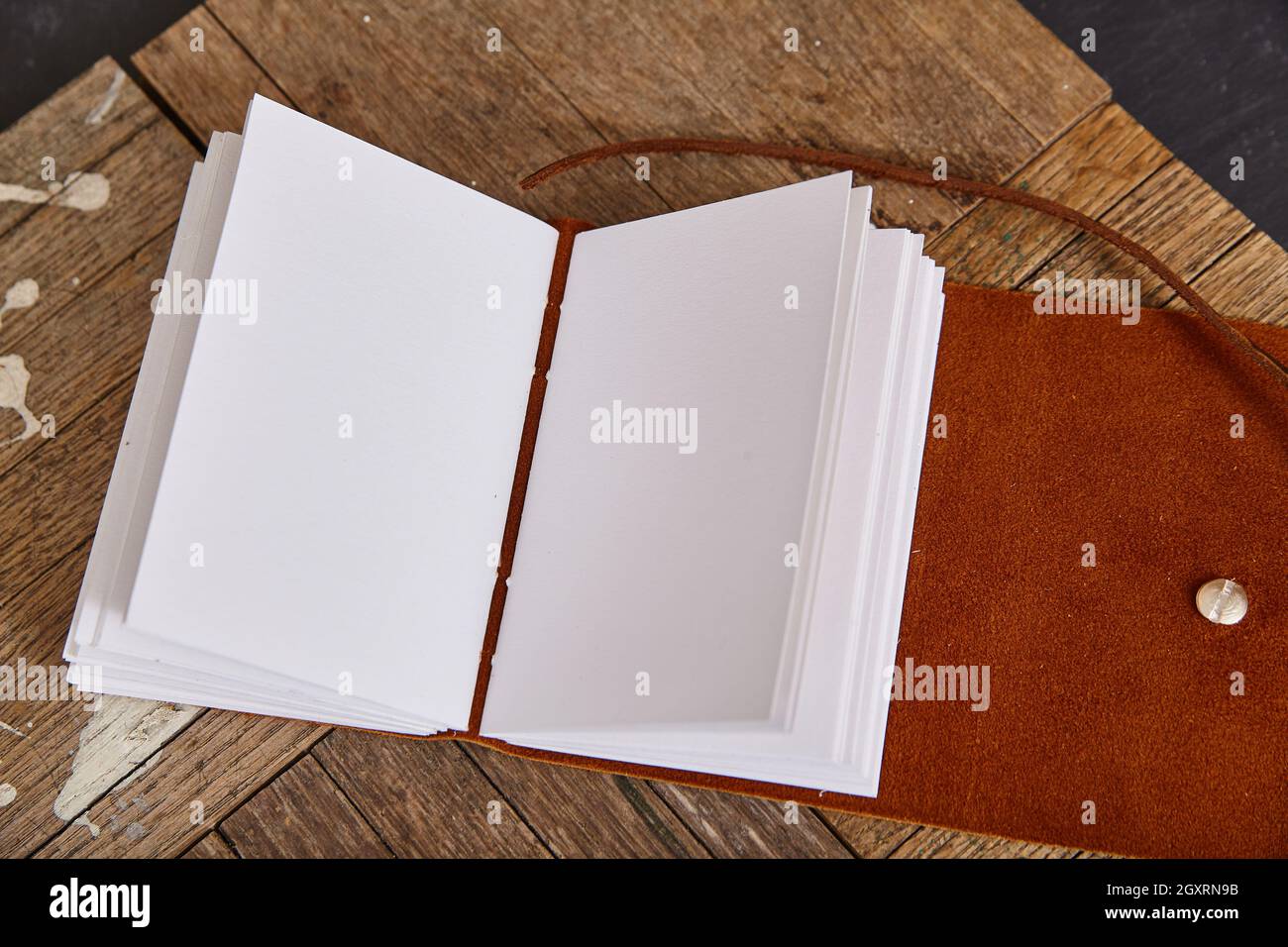 Blank pages of open journal with brown leather on wood planks Stock ...