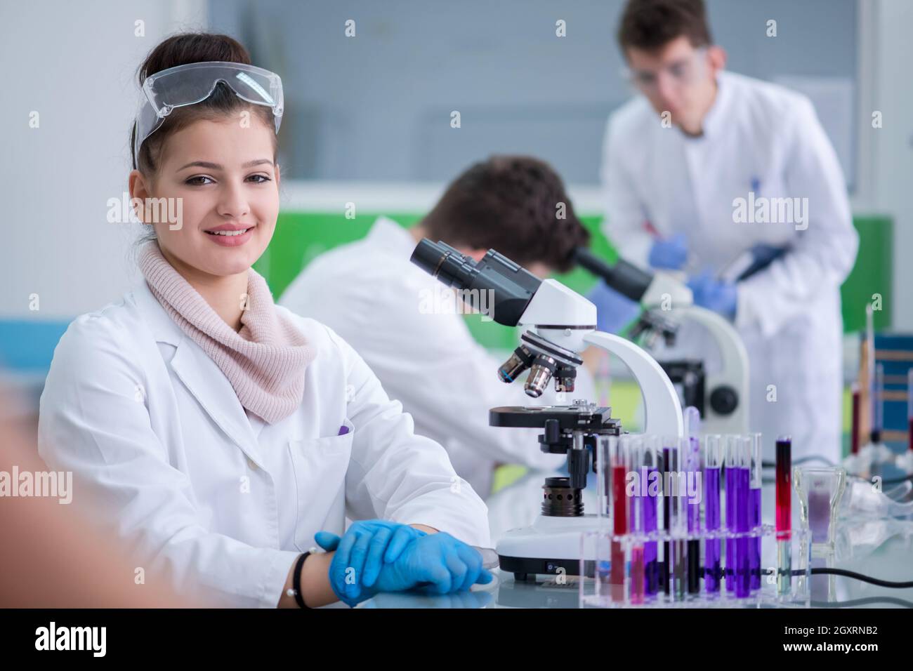 Group of young medical students doing research together in chemistry ...