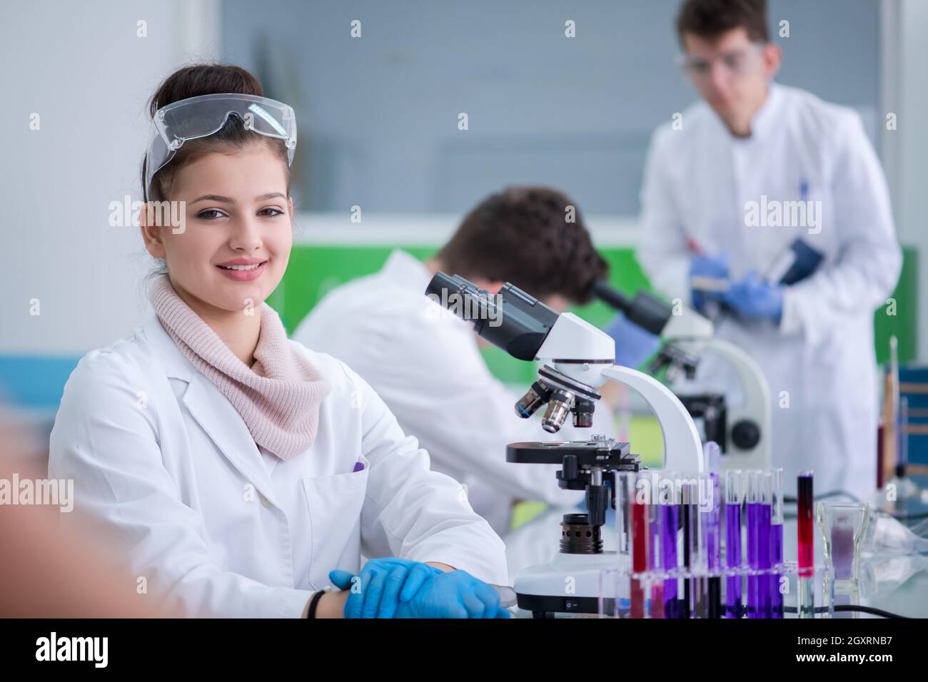 Group of young medical students doing research together in chemistry ...