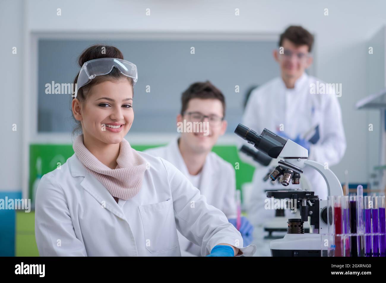 Group of young medical students doing research together in chemistry ...