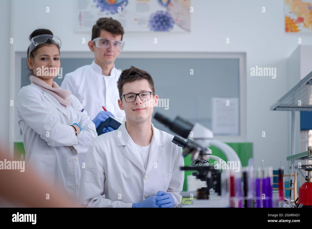 Group of young medical students doing research together in chemistry ...