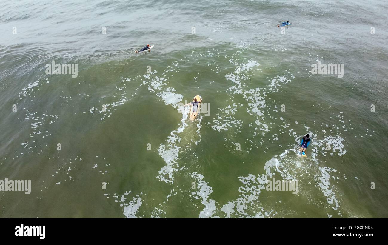 Two surfers on the beach with her boards hi-res stock photography and ...