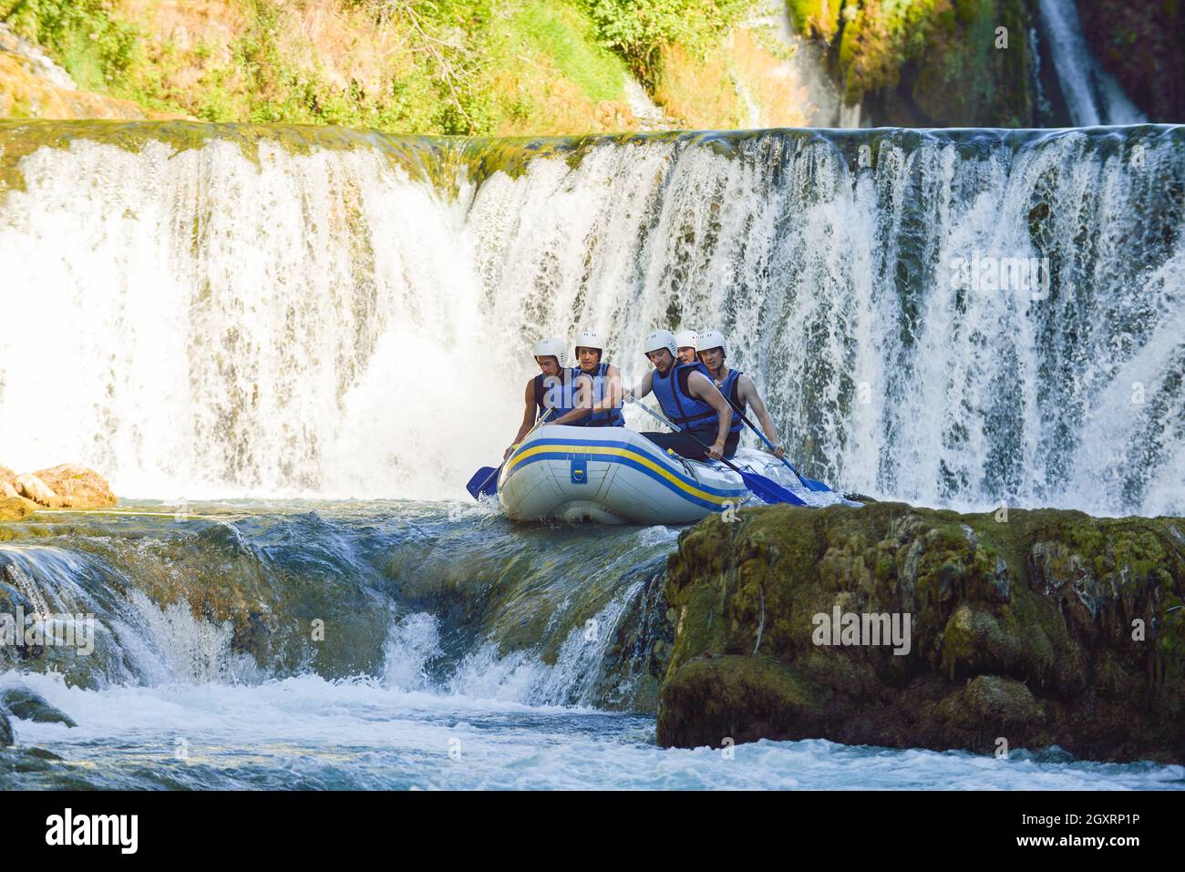 a professional rafting team with guide whitewater rafting and rowing on ...