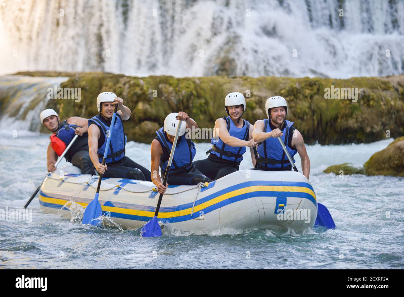 a professional rafting team with guide whitewater rafting and rowing on ...