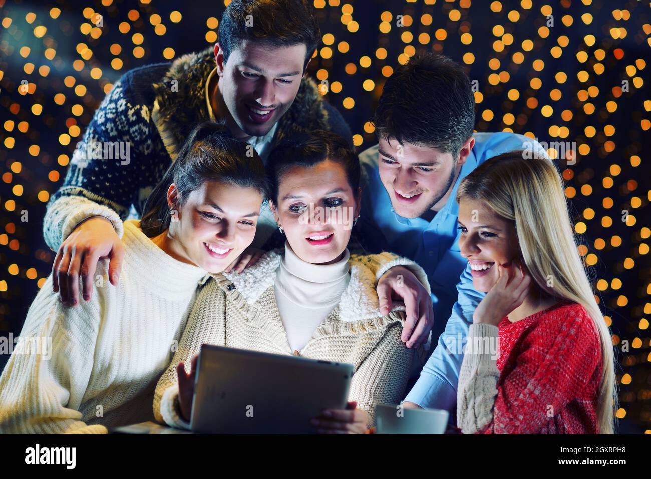Group of happy people looking at a tablet computer Stock Photo - Alamy