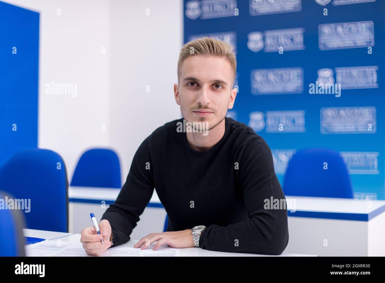 young male student writing notes in the classroom Stock Photo - Alamy