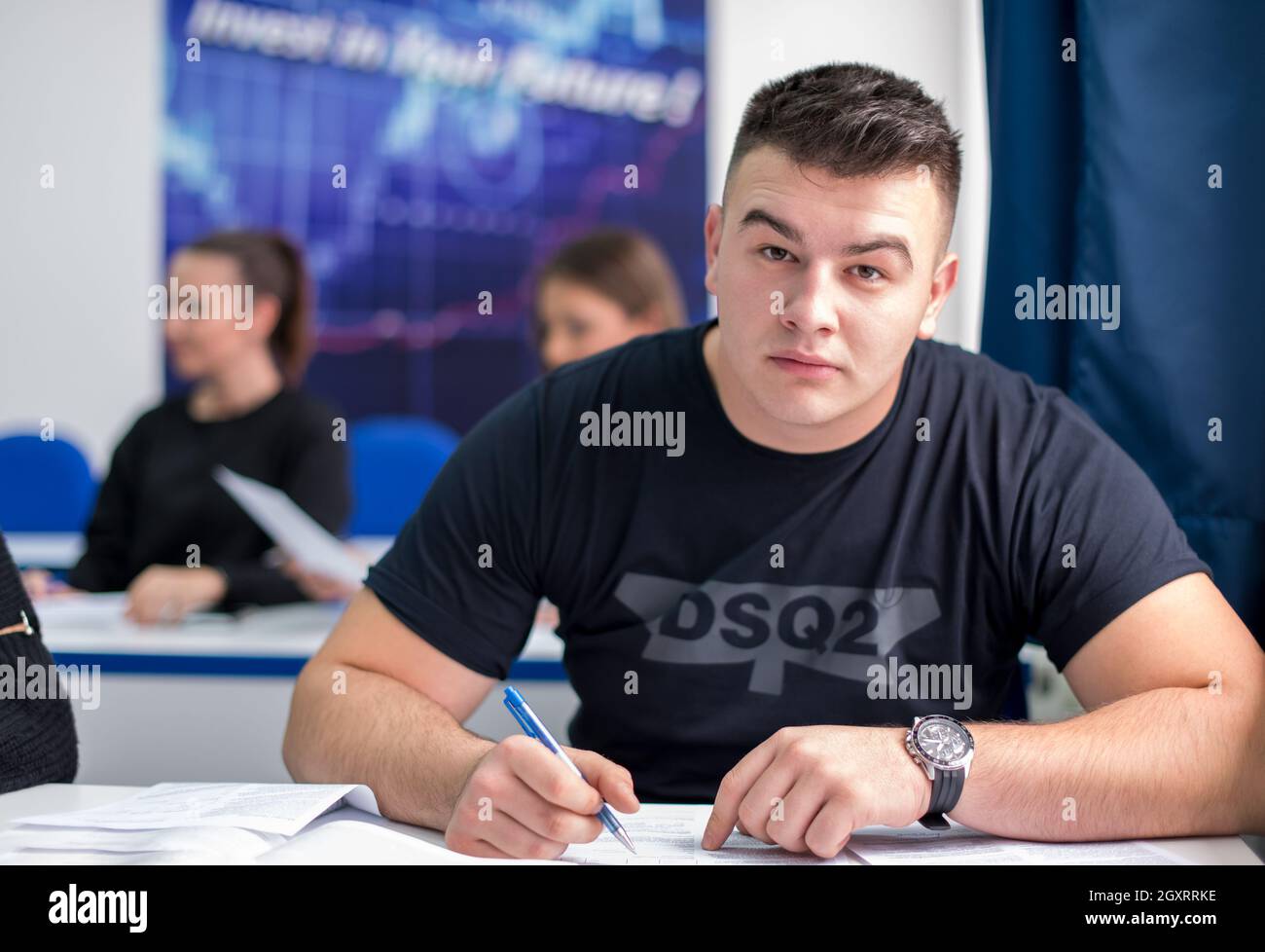 young male student writing notes in the classroom Stock Photo - Alamy