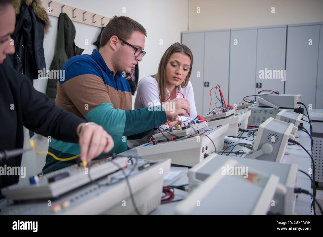 Group of young students doing technical vocational practice with ...