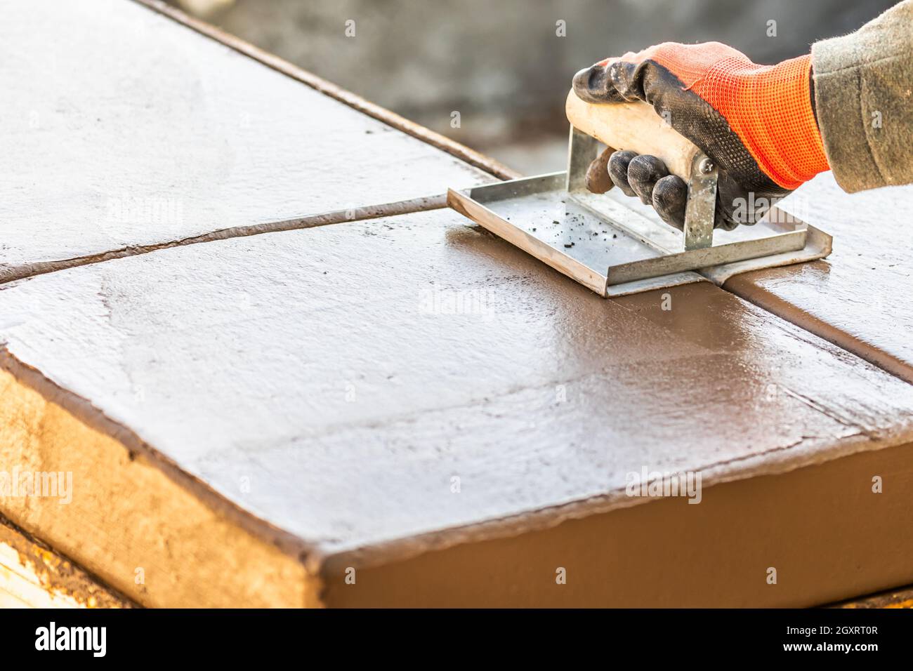 Construction Worker Using Hand Groover On Wet Cement Forming Coping ...