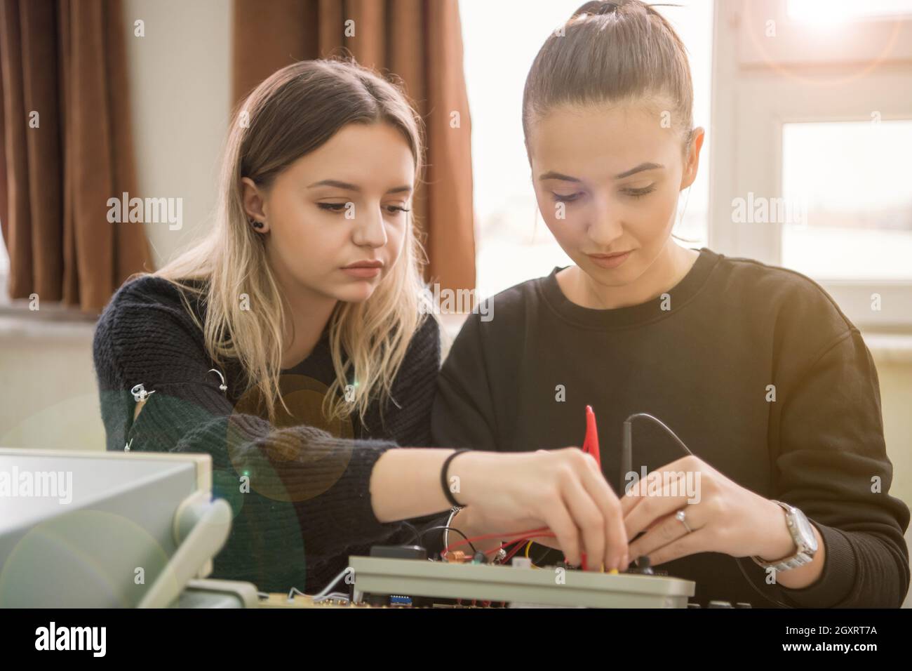 Group of young students doing technical vocational practice with ...