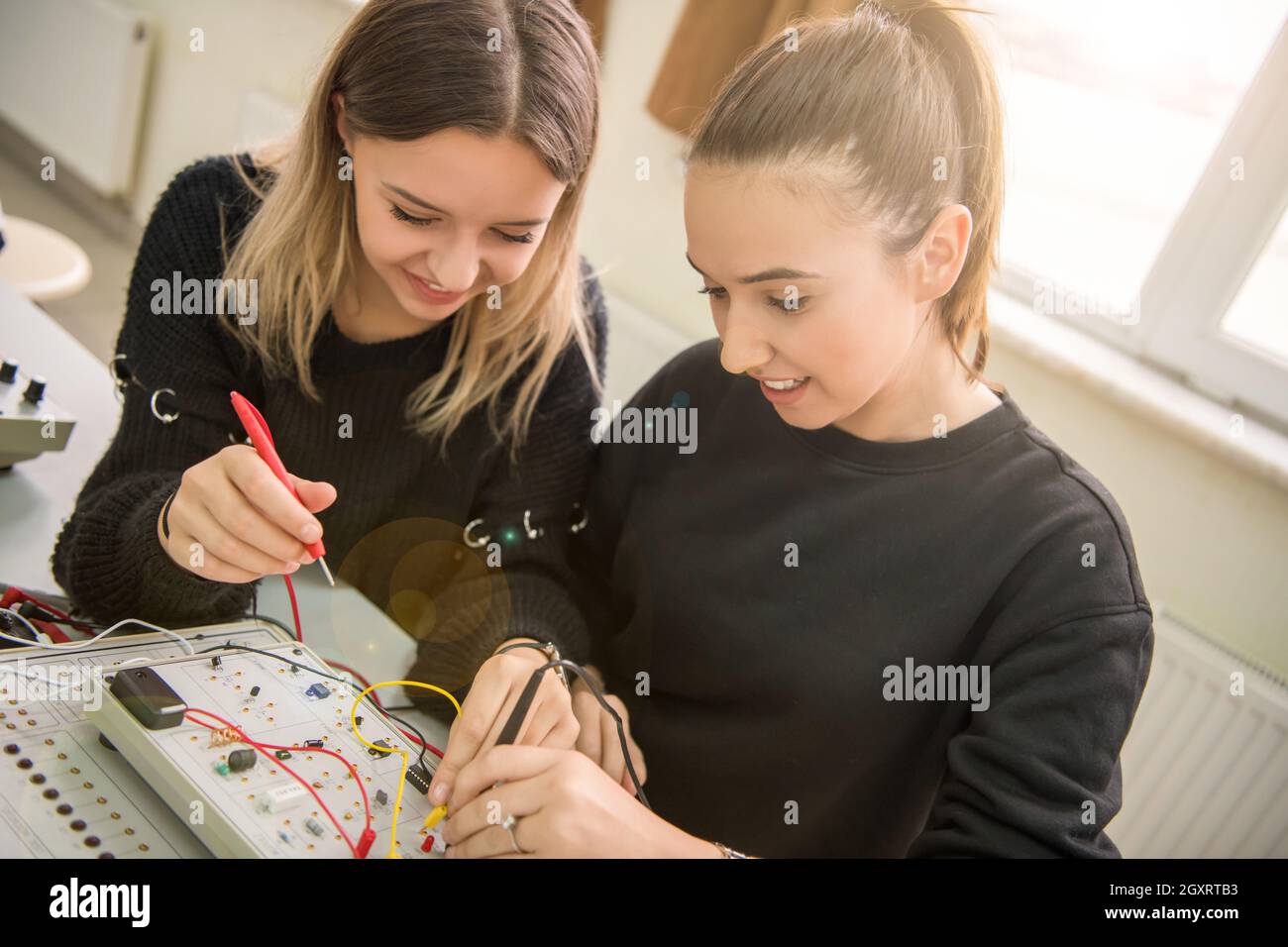 Group of young students doing technical vocational practice with ...