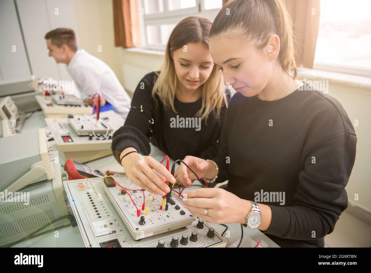 Group of young students doing technical vocational practice with ...