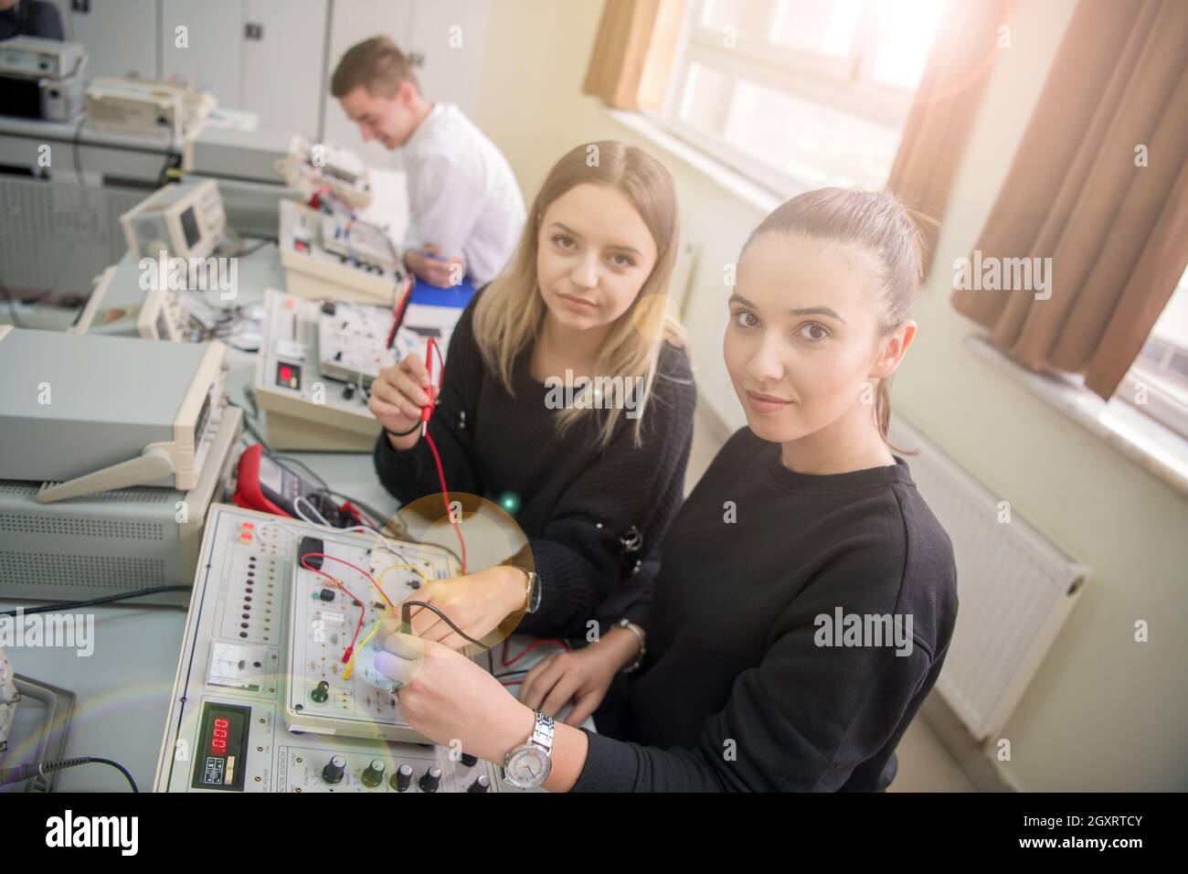 Group of young students doing technical vocational practice with ...