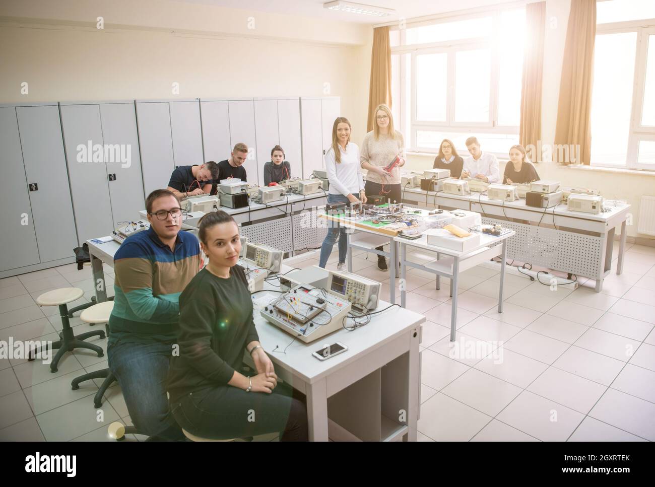 Group of young students doing technical vocational practice with ...
