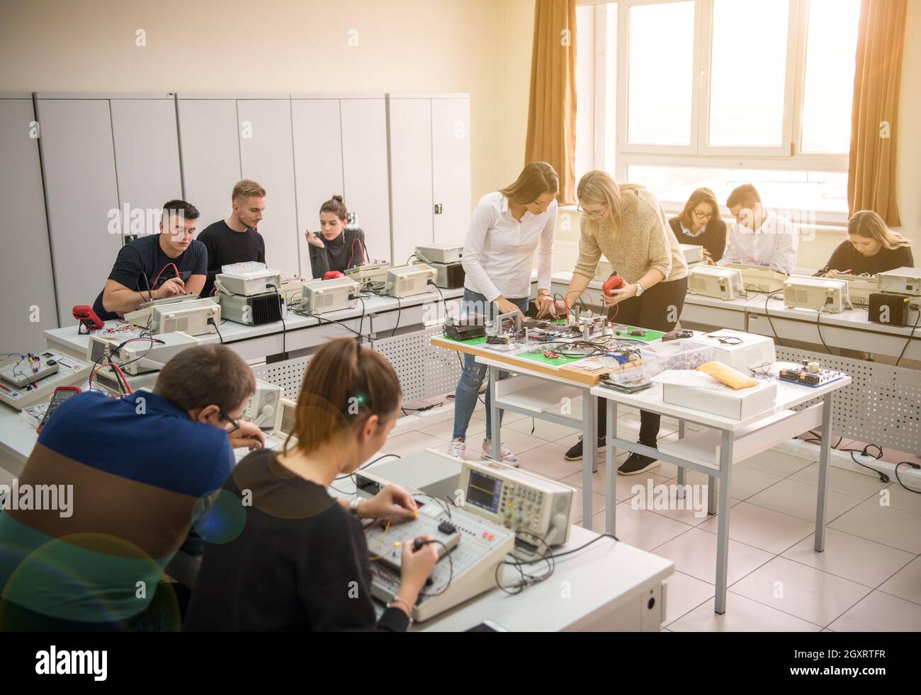 Group of young students doing technical vocational practice with ...
