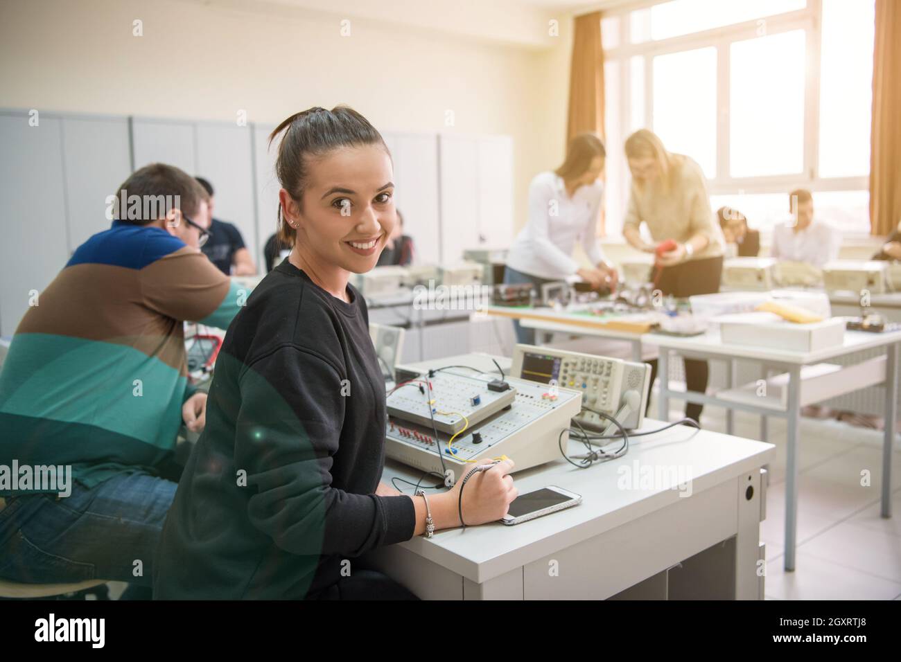 Group of young students doing technical vocational practice with ...