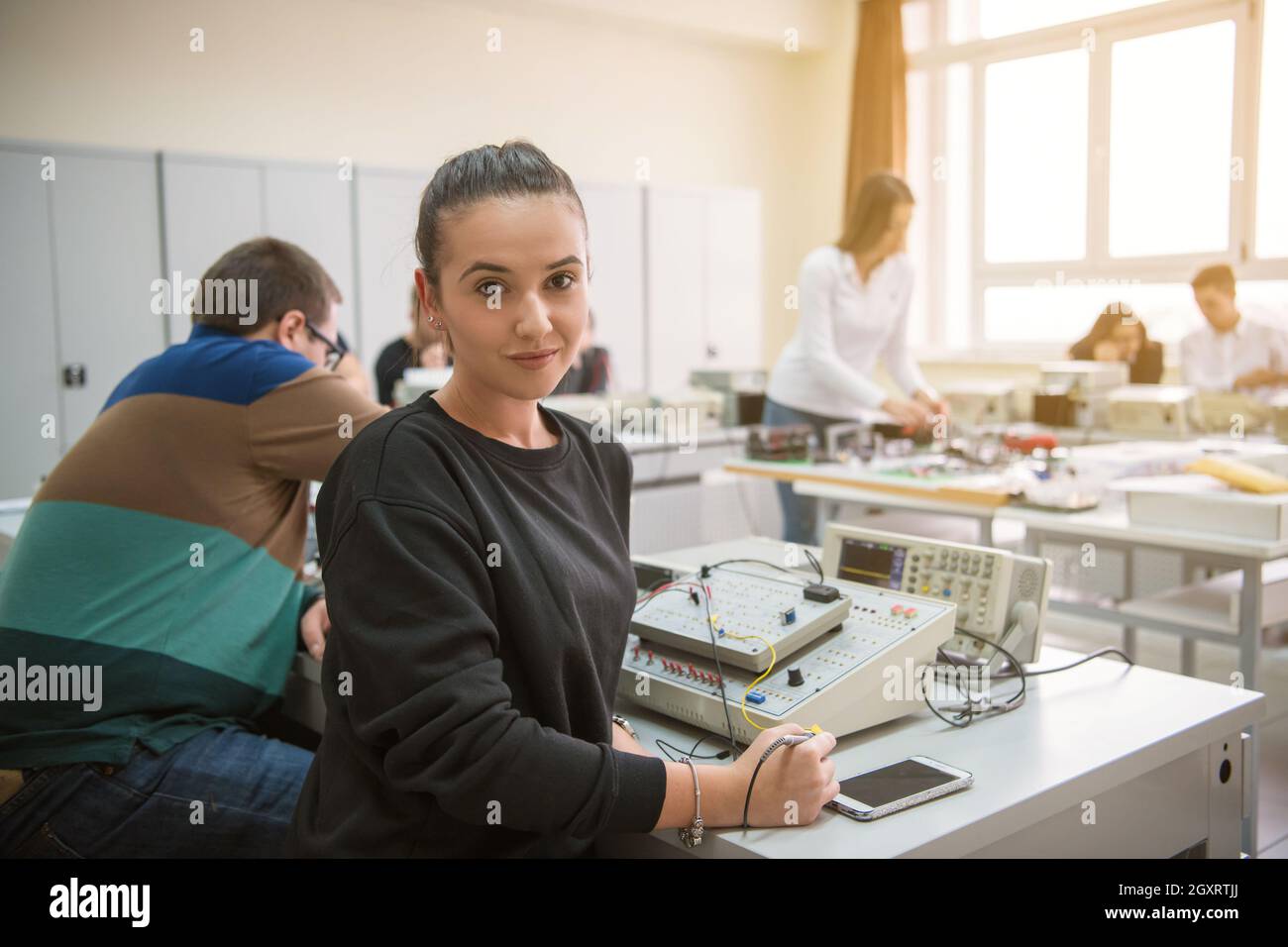 Group of young students doing technical vocational practice with ...