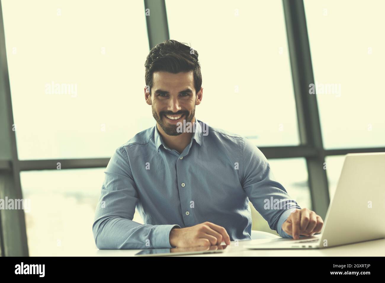 happy young business man work in modern office on computer Stock Photo ...