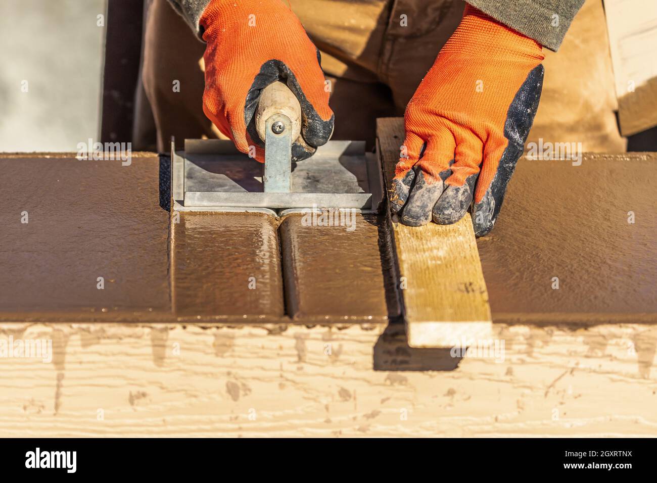 Construction Worker Using Hand Groover On Wet Cement Forming Coping ...