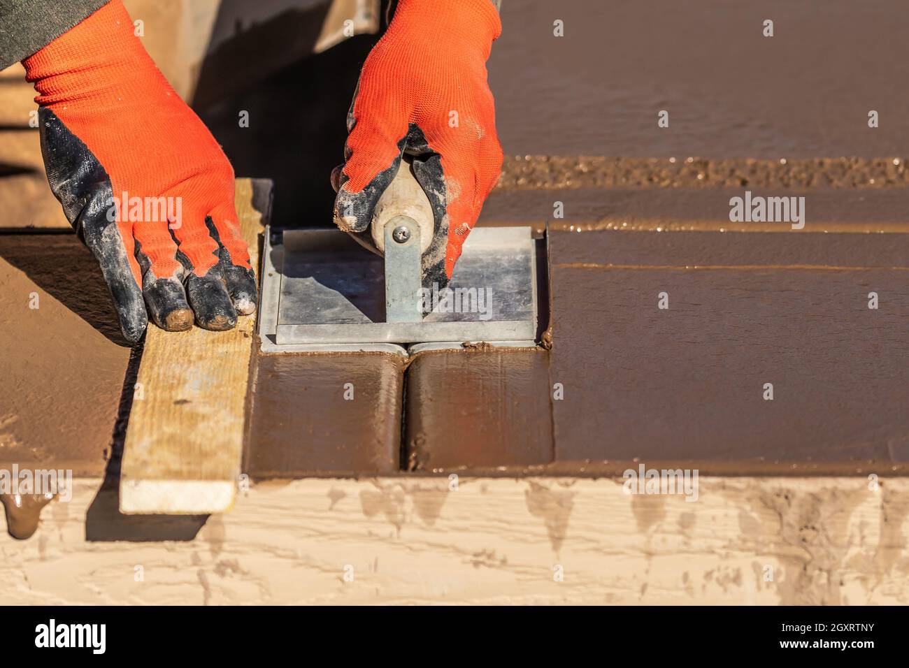 Construction Worker Using Hand Groover On Wet Cement Forming Coping ...