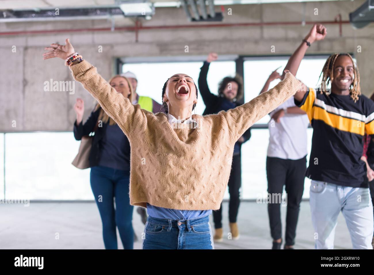 happy multiethnic business team dancing during moving in at new ...