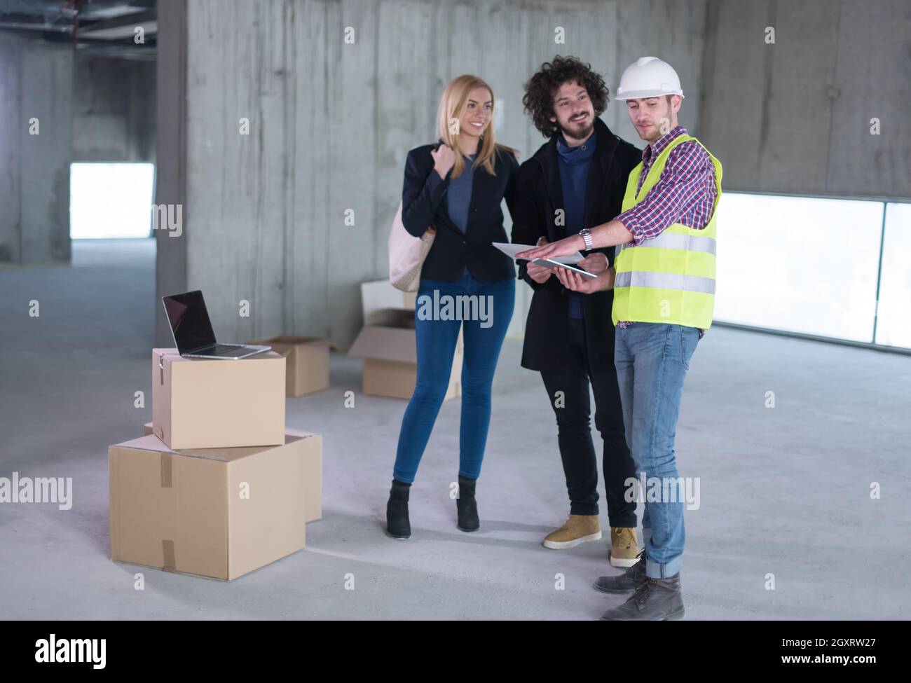 architect using tablet computer while showing house design plans to a ...