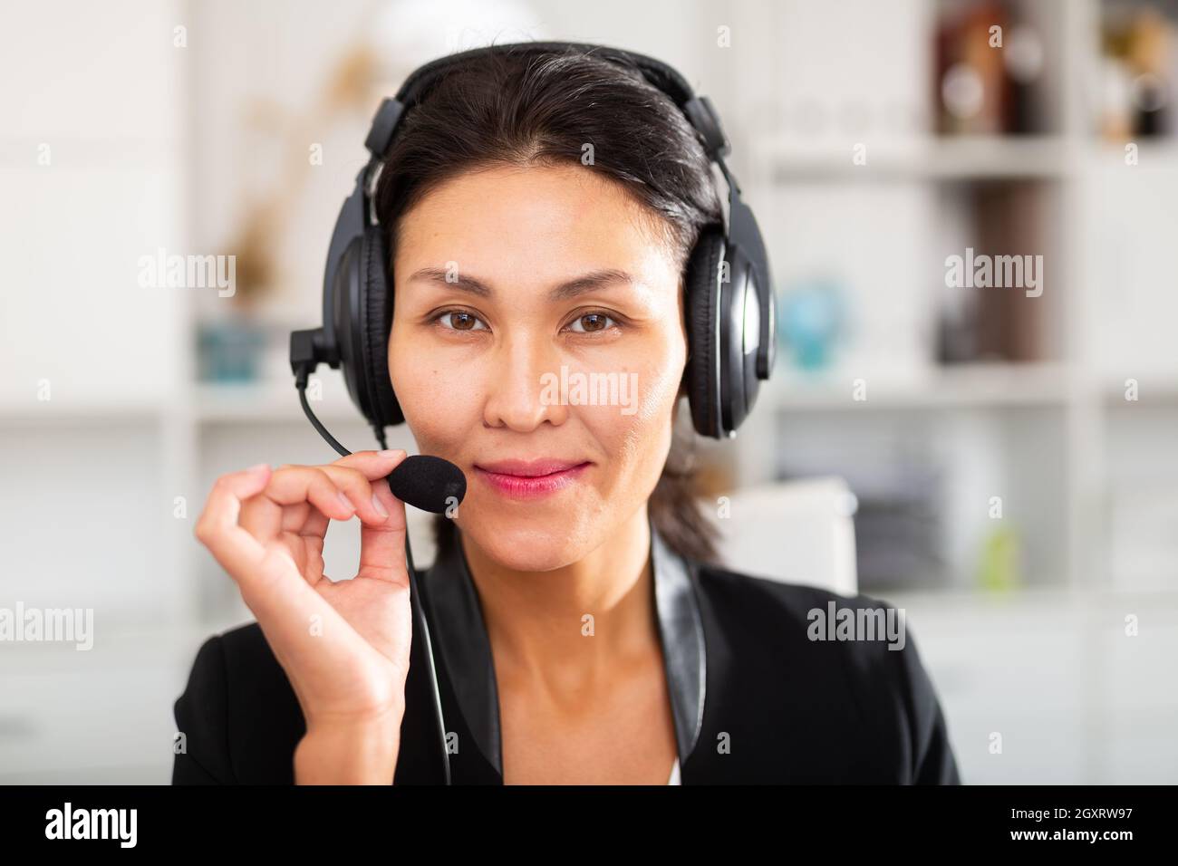 Portrait of woman call centre operator with headphones in office Stock ...
