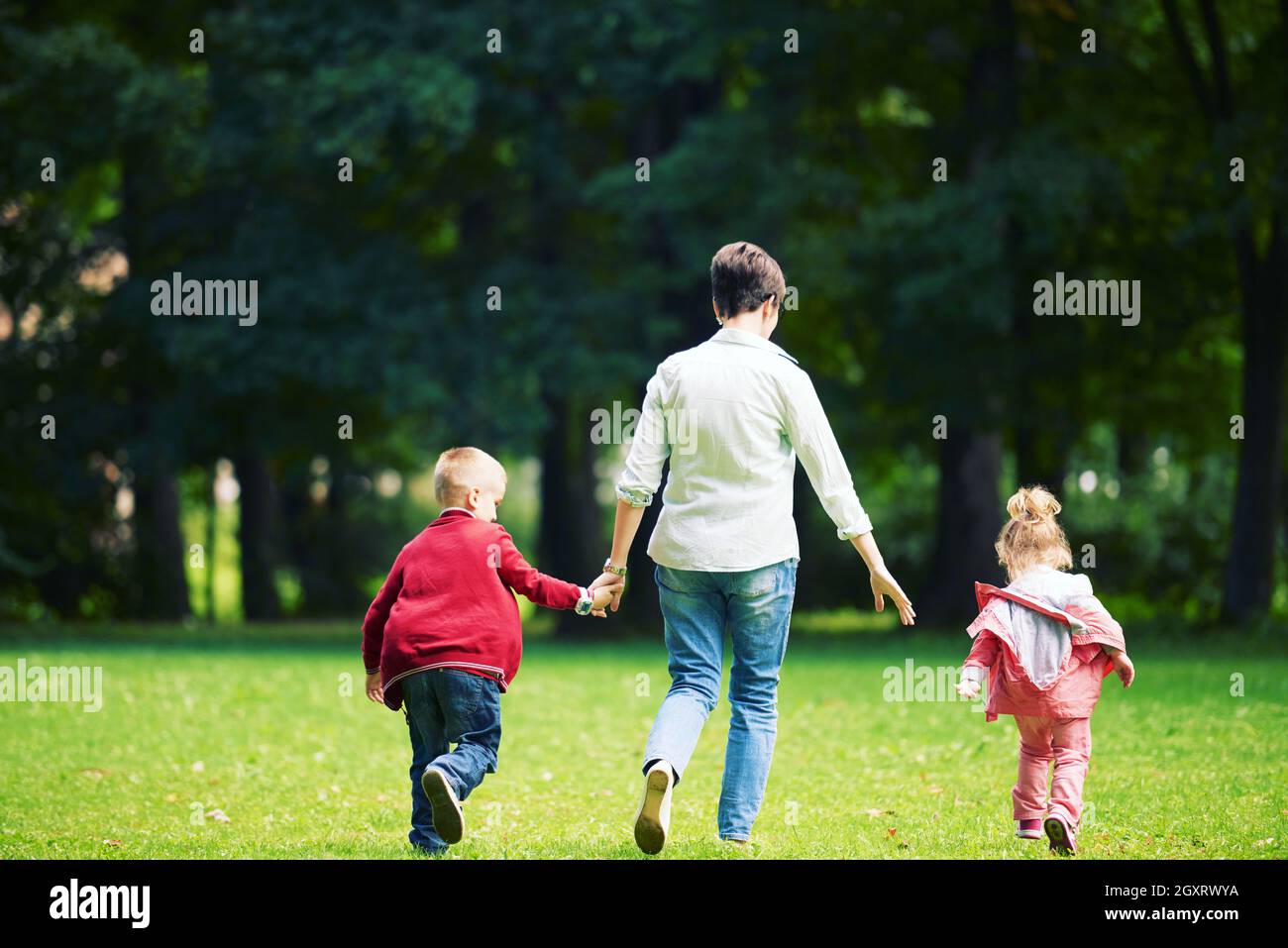happy family playing together outdoor in park mother with kids running ...