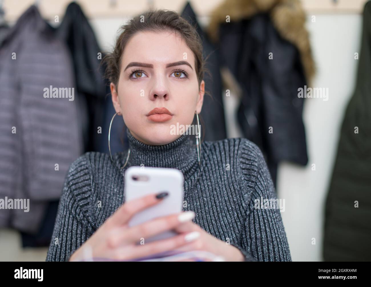 young female student using a mobile phone during the break in the ...