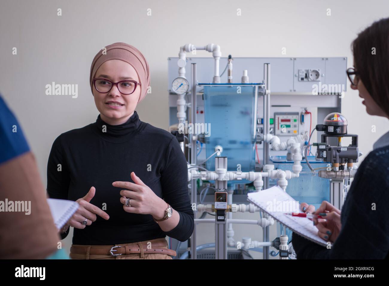 Group of students doing technical vocational practice with young female ...