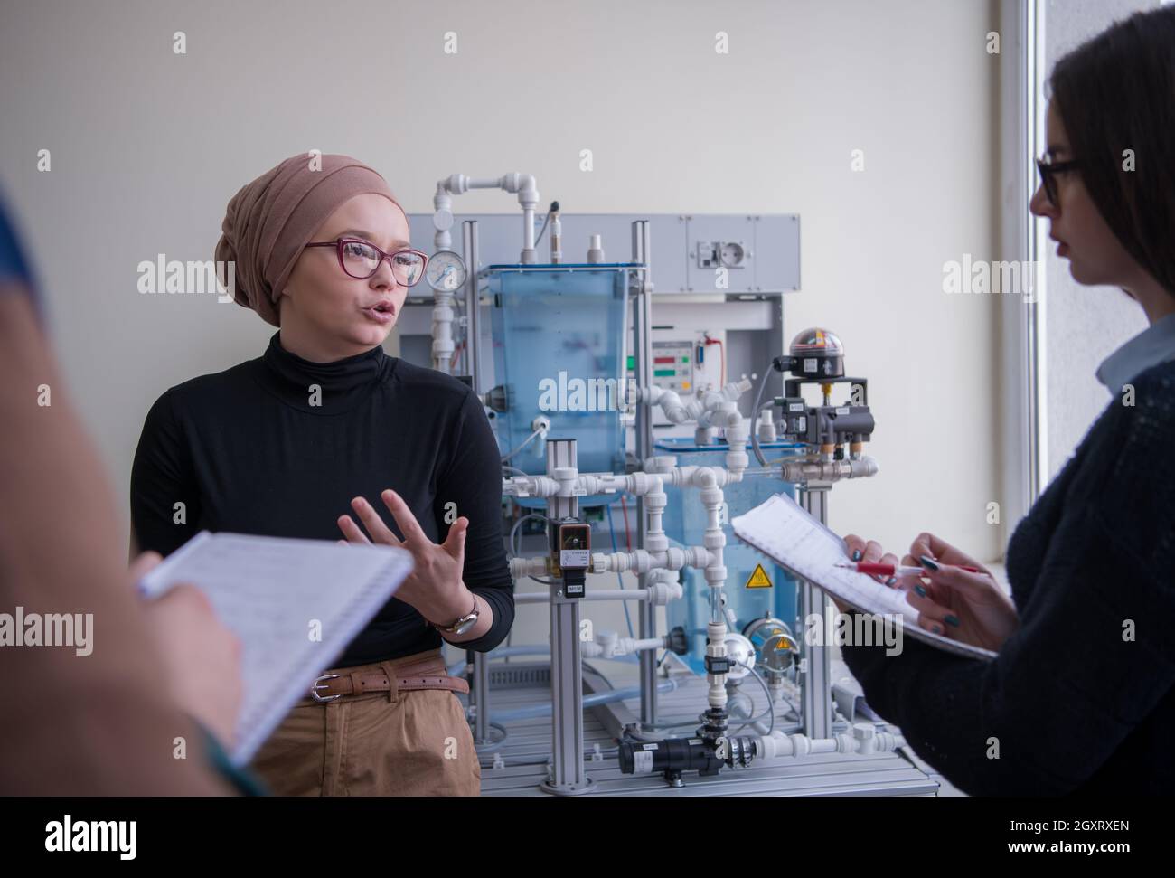 Group of students doing technical vocational practice with young female ...