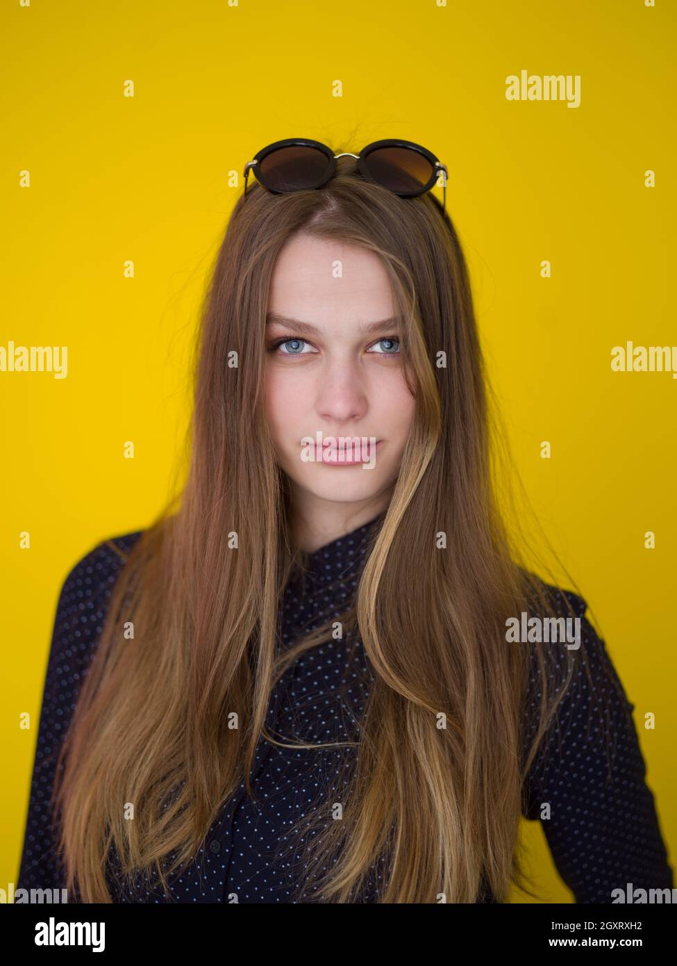 portrait of Beautiful young woman isolated on yellow background Stock ...