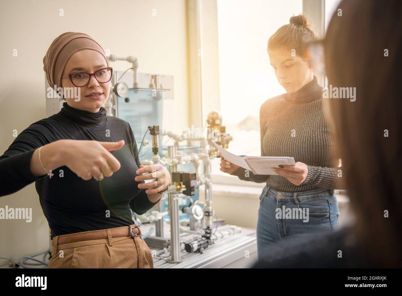 Group of students doing technical vocational practice with young female ...