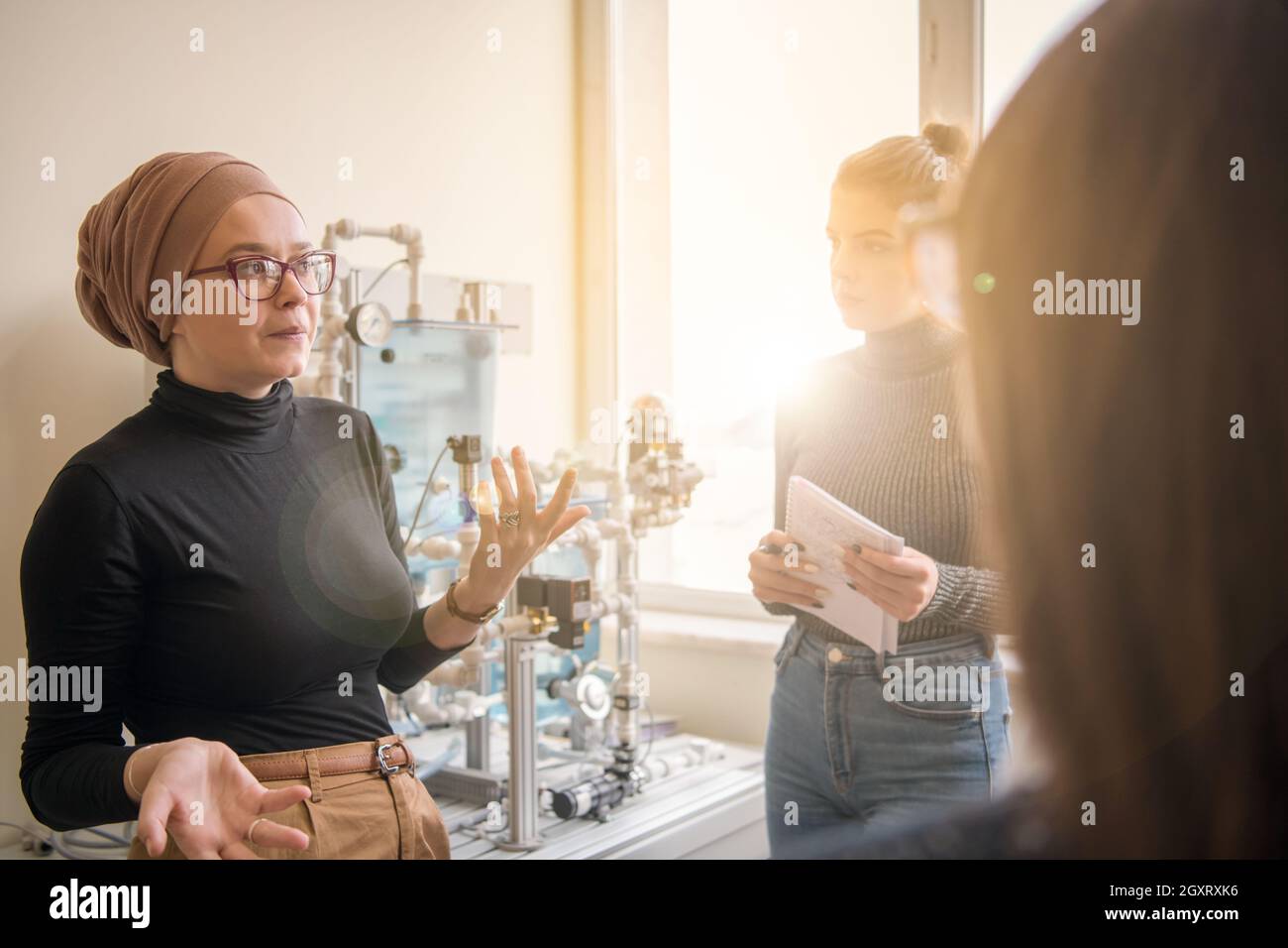 Group of students doing technical vocational practice with young female ...