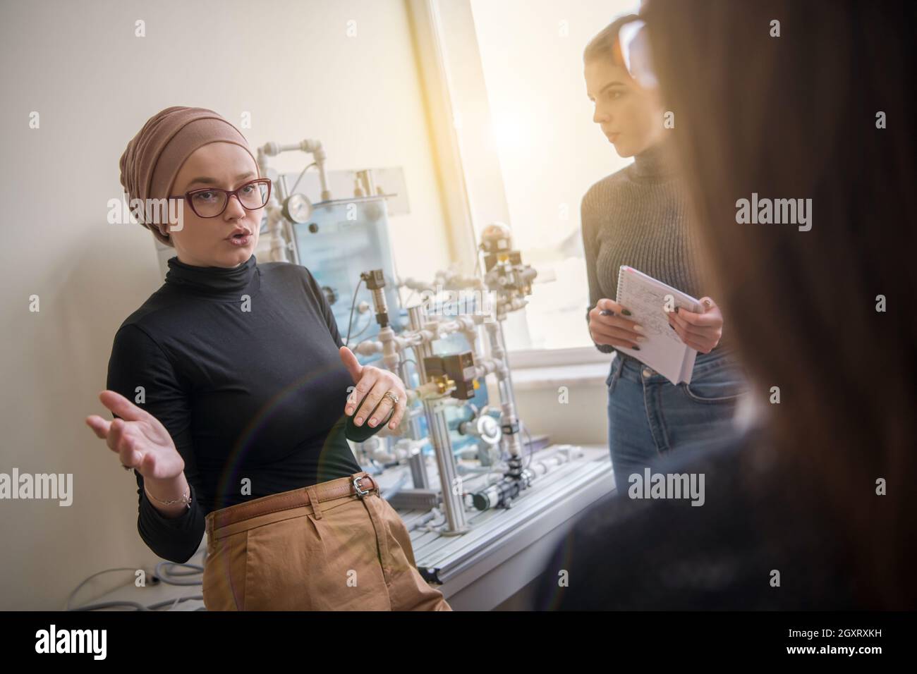 Group of students doing technical vocational practice with young female ...
