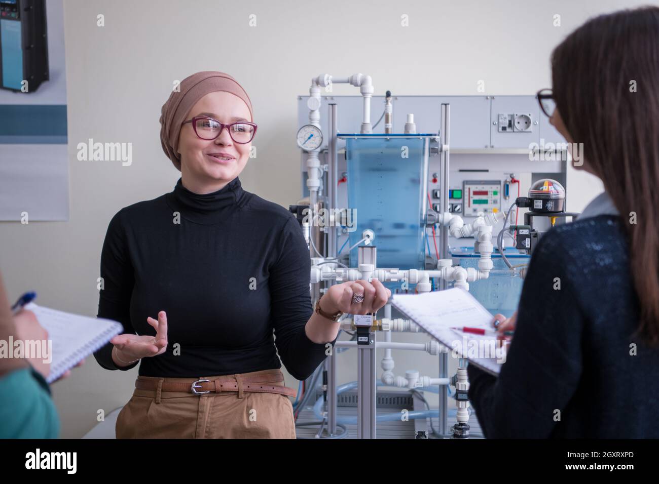 Group of students doing technical vocational practice with young female ...