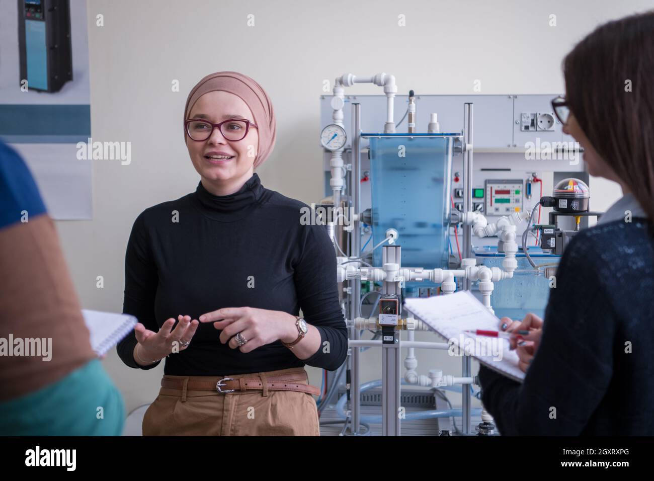 Group of students doing technical vocational practice with young female ...