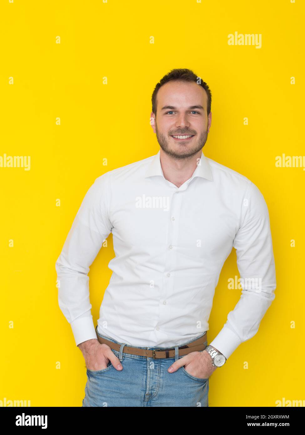 portrait of a handsome young man isolated over a yellow background ...