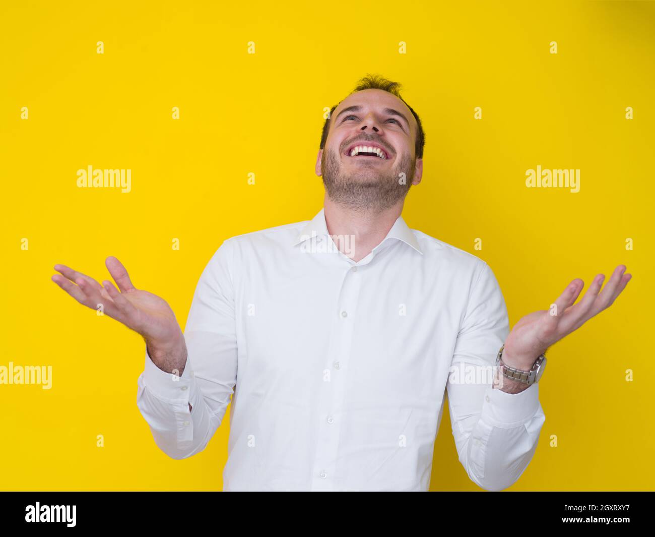 portrait of a handsome young man isolated over a yellow background ...
