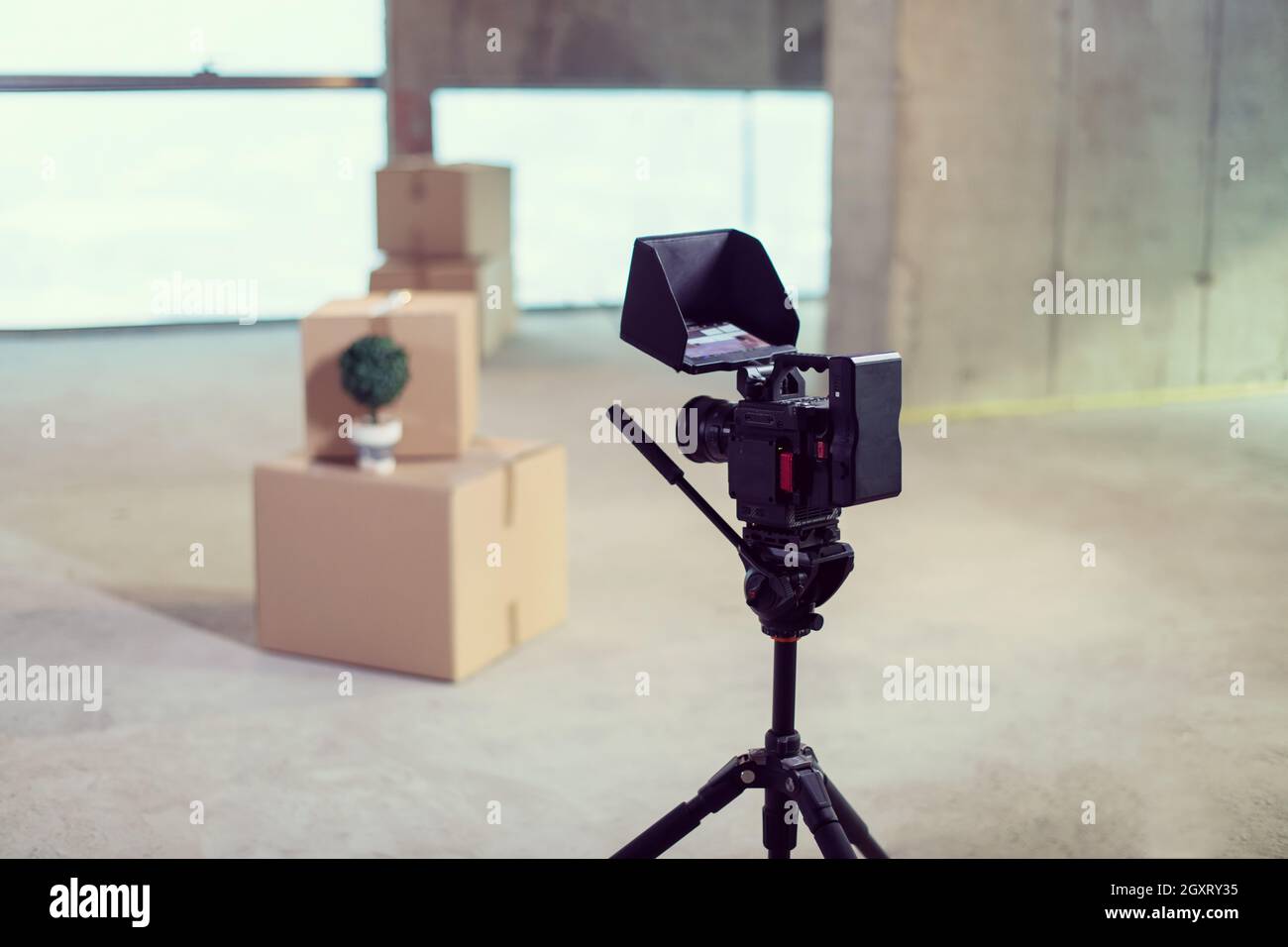 Professional video camera set on a tripod Stock Photo - Alamy