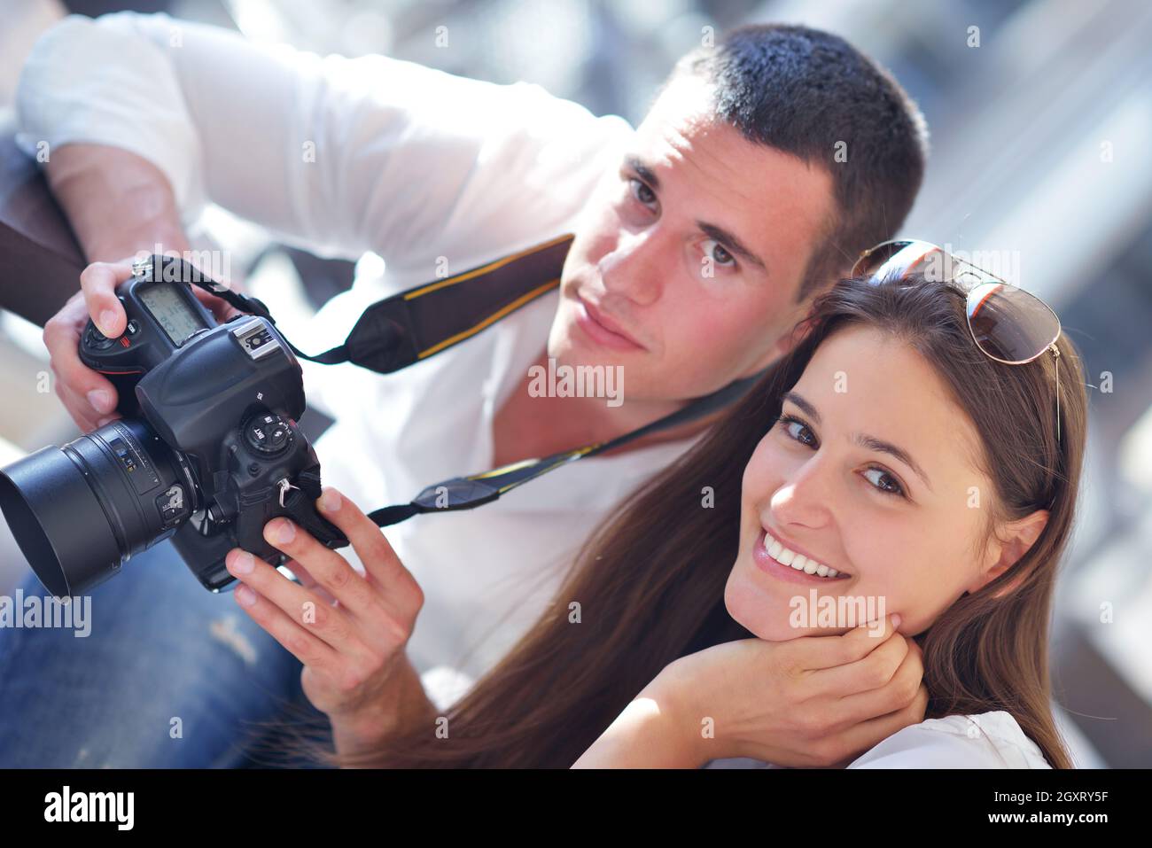 happy young romantic couple looking photos on camera Stock Photo - Alamy